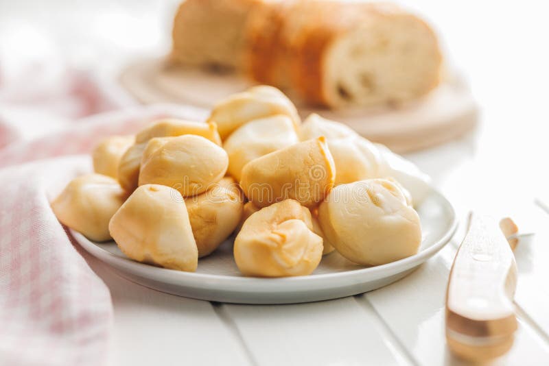 Smoked Mini Scamorza Cheese. Traditional Italian Cheese on Plate on ...