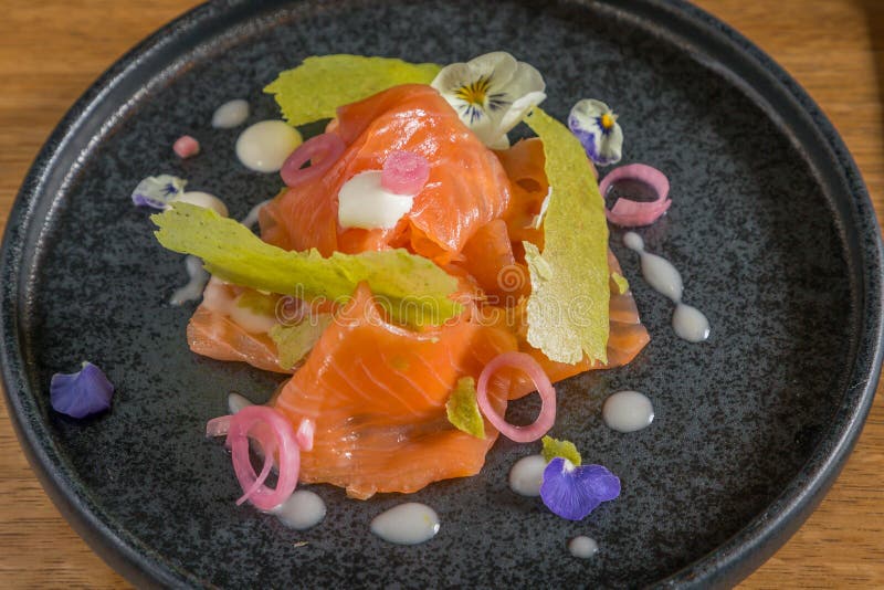 Smoked Salmon with Herb Tuile and Edible Flowers Stock Photo - Image of ...