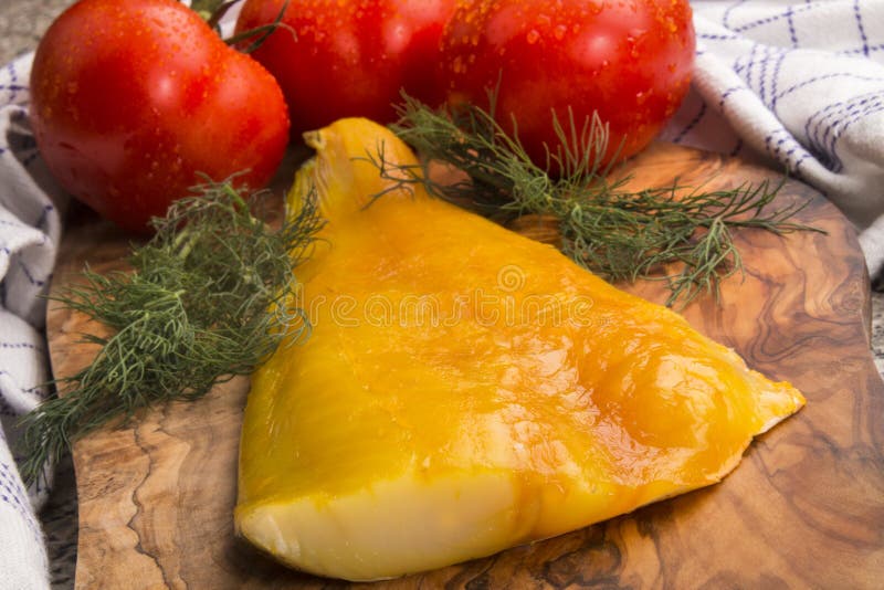 Smoked Scottish Haddock on a Wooden Board with Wet Tomato Stock Photo ...