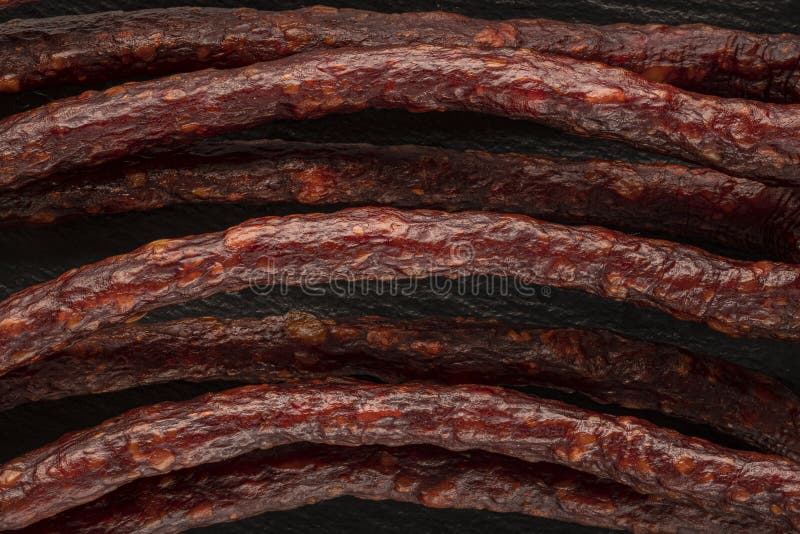 Smoked Thin Sausage Long, Texture on a Black Background. the View from ...