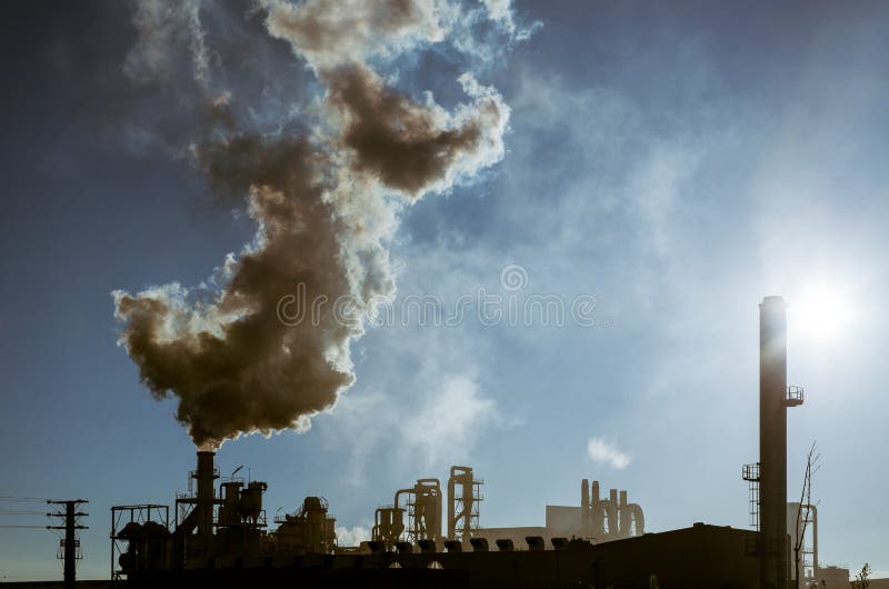 Smoking chimney at sunset stock photo. Image of storage - 34000338