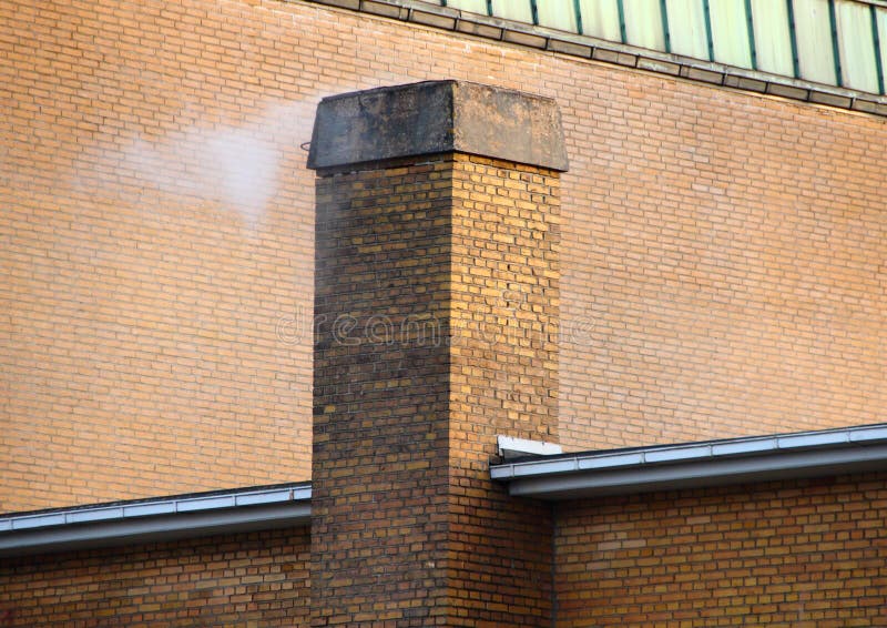 Smoking Chimney on Yellow Brick Tile Building Stock Photo - Image of ...