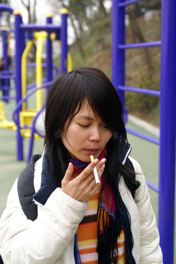 Smoking chinese girl stock image. Image of cigarette, outdoor - 5997163