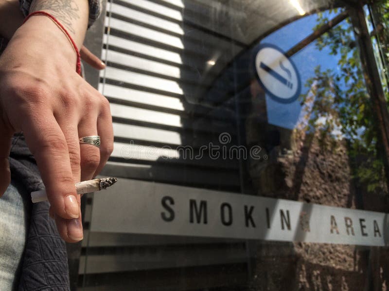 Smoking a cigarette stock image. Image of street, area - 72245139