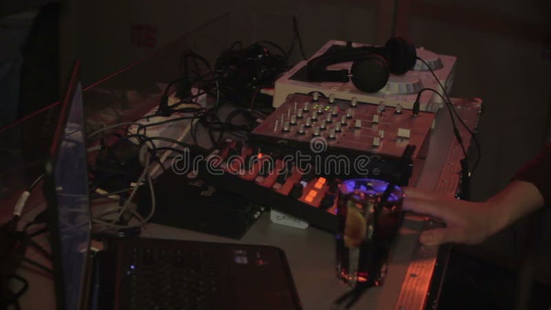 Smoking DJ Standing at the Mixing Console and Pushing Buttons ...