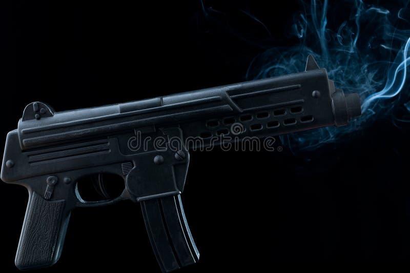 A smoking machine gun stock photo. Image of fire, weapon - 12674342