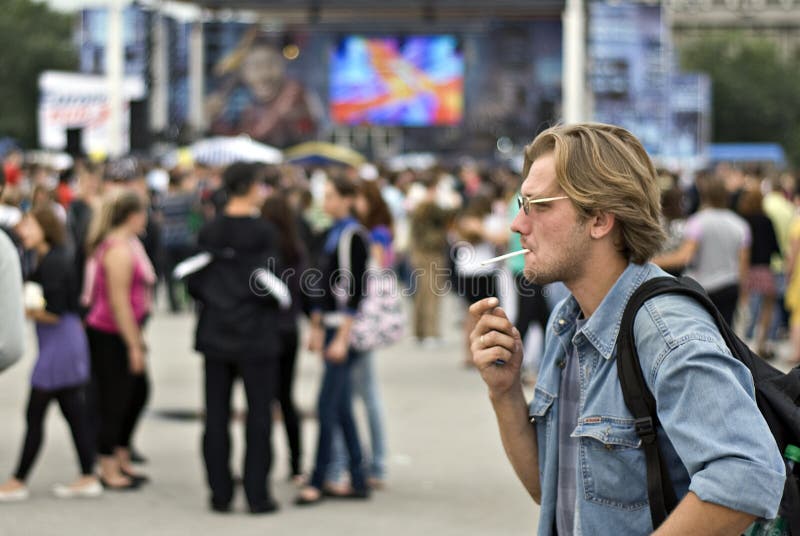 The smoking men in crowd editorial photo. Image of outdoors - 15688741