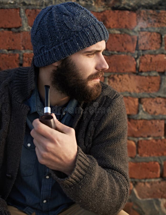 Smoking a Pipe. a Bearded Man Smoking a Pipe Outside. Stock Image ...