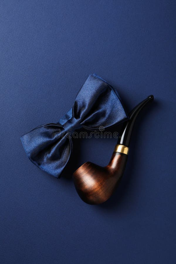 Smoking Pipe and Tie Bow on Blue Background Stock Image - Image of ...