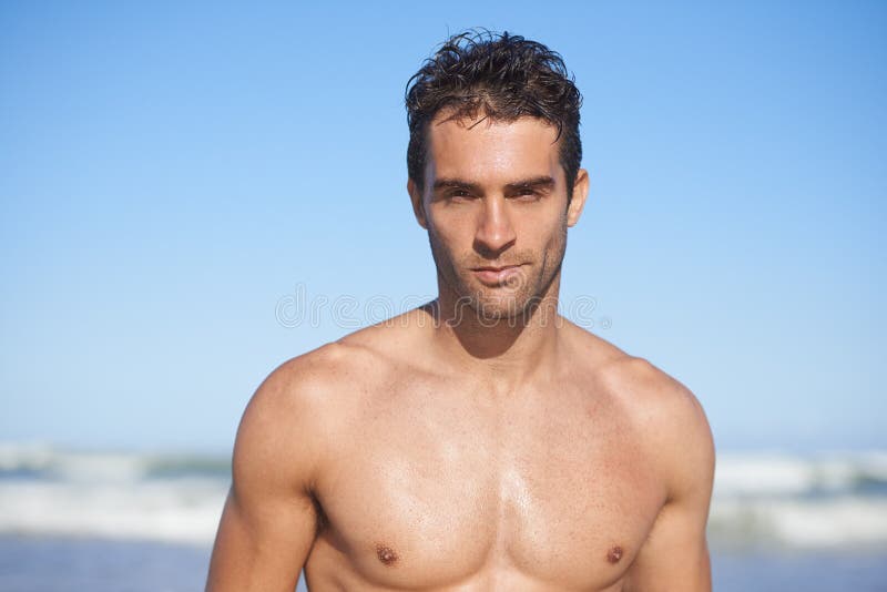 Smoldering Looks Cropped Portrait Of A Handsome Man At The Beach