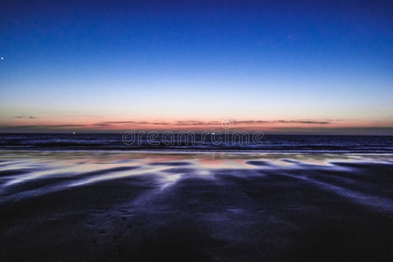 Smooth beach sunset stock image. Image of ocean, skies - 122745575
