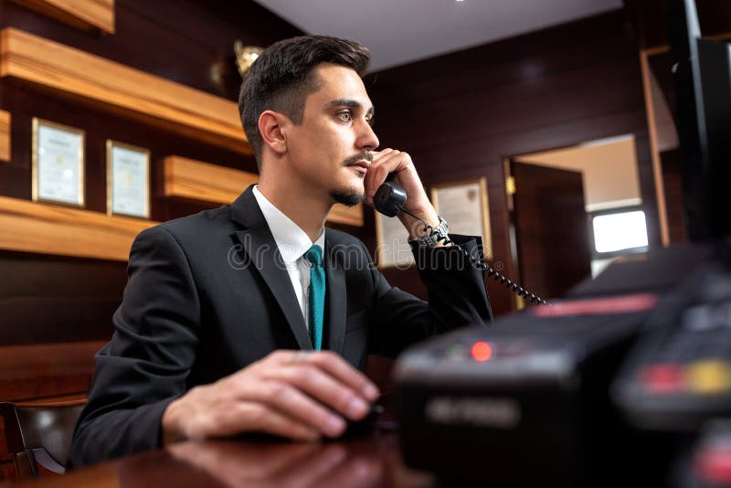 Smooth Hotel Reception Worker Talking on the Phone Stock Image - Image ...