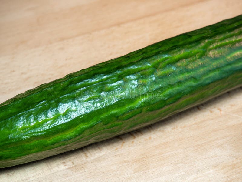 Smooth Medium Cucumber. Cucumber on a Cutting Board Stock Photo - Image ...