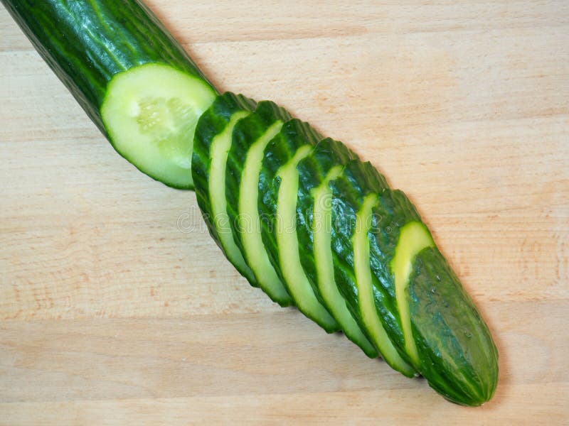 A Smooth, Medium-sized Cucumber Cut into Slices. Cucumber on a Cutting ...