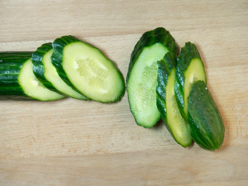 A Smooth, Medium-sized Cucumber Cut into Slices. Cucumber on a Cutting ...