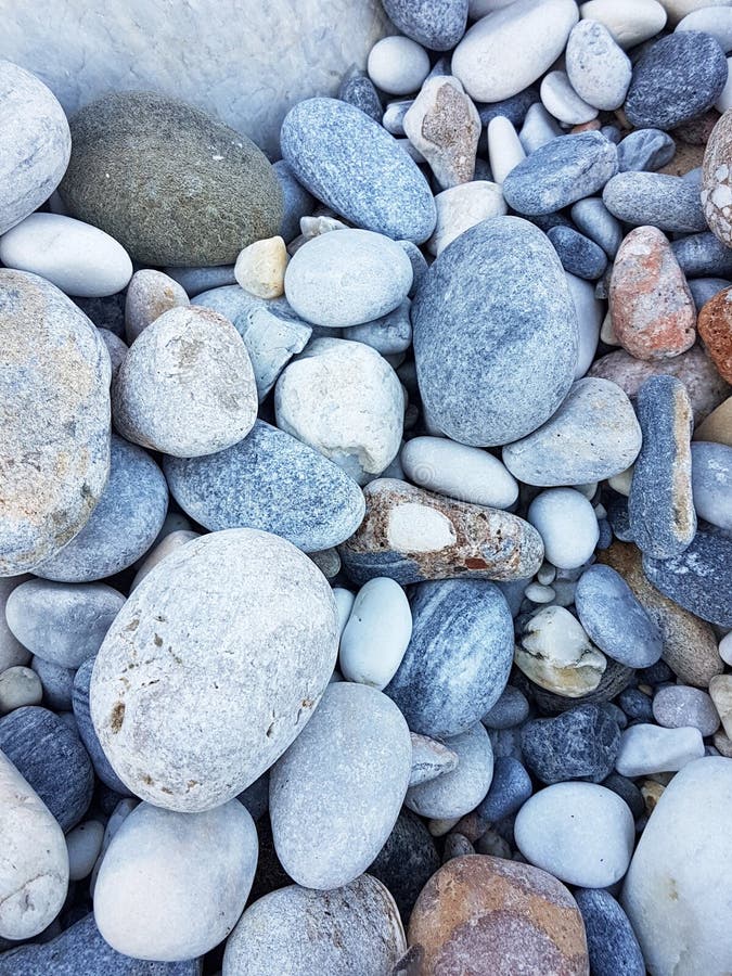 Smooth Pebbles on a Pebble Beach Stock Photo - Image of rocks, blue ...
