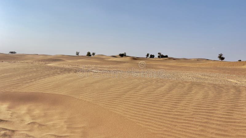 Smooth Sandy Surface of a Desert with Blue Sky in the Background Stock ...