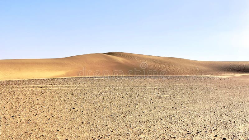 Smooth Sandy Surface of a Desert with Blue Sky in the Background Stock ...