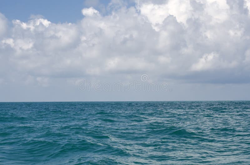 Smooth Sea Surface Against a Background of a Cloudy Sky. Stock Photo ...