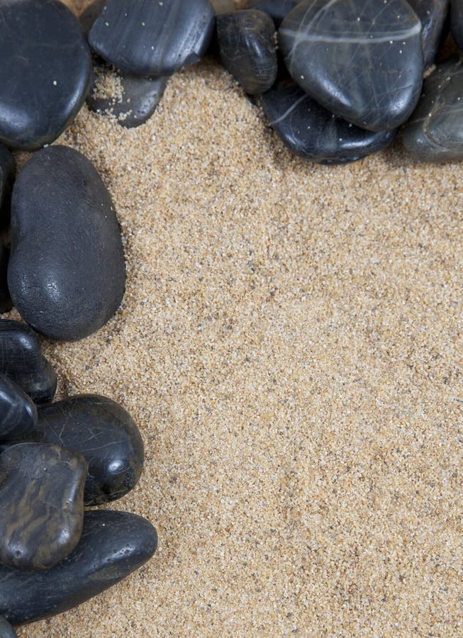 Smooth stones on sand stock photo. Image of black, rocks - 18496286