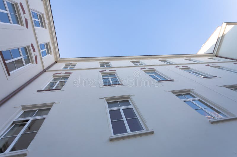 The Smooth Wall of the Building with Large Windows Seen from the Very ...