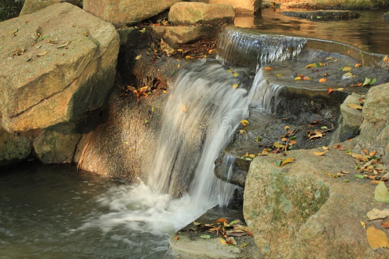 Smooth Waterfall Among Rocks In Autumn Stock Photo - Image of flowing ...