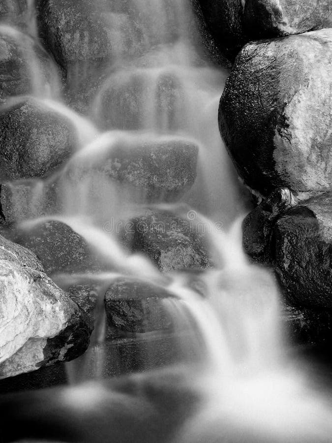 Smooth waterfall and rocks stock photo. Image of white - 5469666
