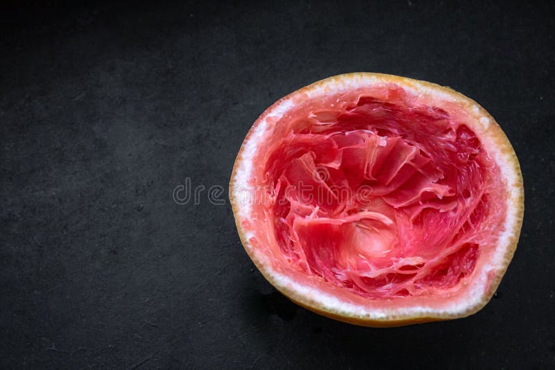 Half Squeezed Grapefruit on Black Background Stock Image - Image of ...