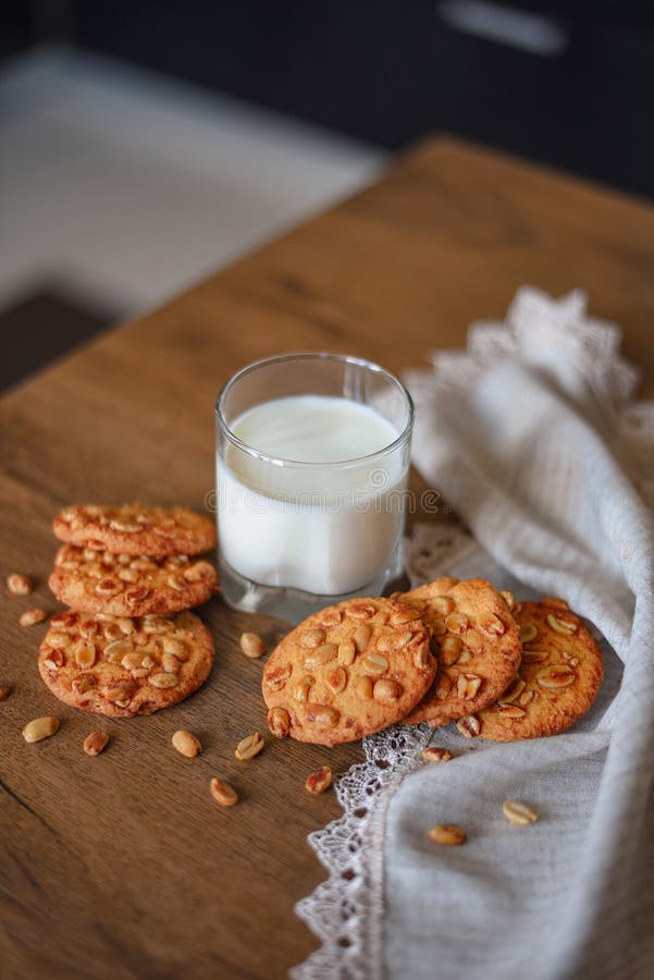 Snack of Milk and Buiscuits with Nuts on the Wooden Kitchen Table Stock ...