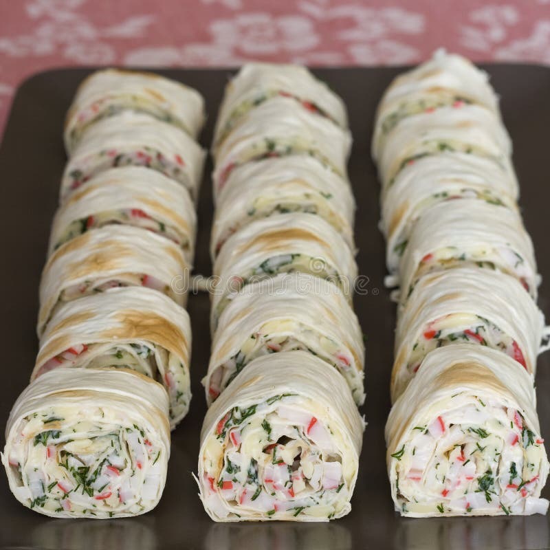 Snack Roll of Pita Bread with Korean Carrots on Plate Stock Photo ...