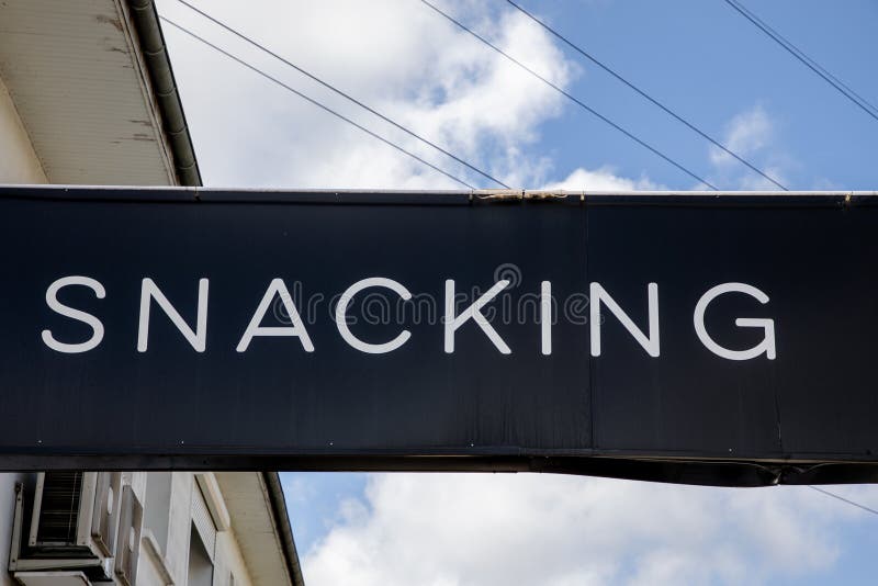 Snacking Text Sign Hanging in Front of a Restaurant Stock Image - Image ...