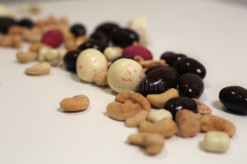 Snacks: Nuts & Chocolates on a White Table Stock Photo - Image of ...