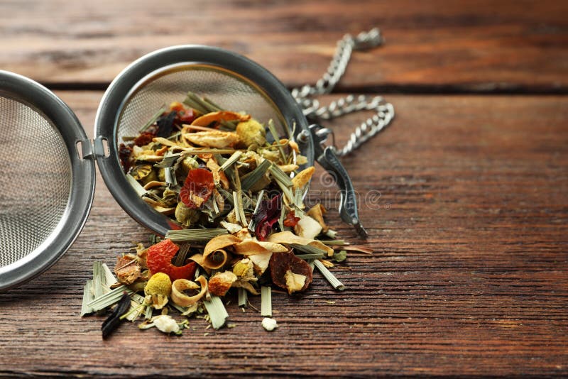 Snap Infuser with Dried Herbal Tea Leaves on Wooden Table, Closeup ...