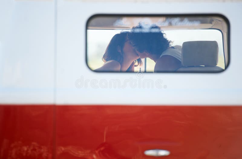 Sneaking a Quick Kiss. Window -view of Two Young Lovers Embracing ... Sneaking a Quick Kiss. Window -view of Two Young Lovers Embracing ...