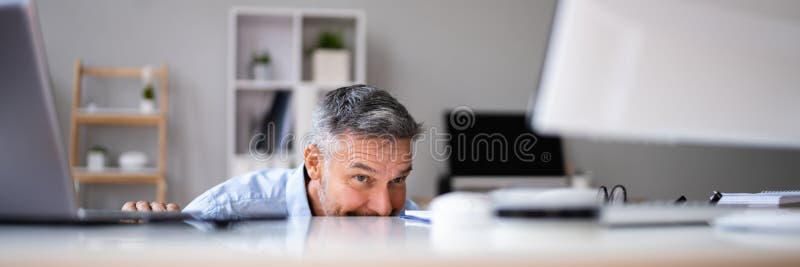 Sneaky Mature Man Avoiding Work Stock Photo - Image of office, male ...