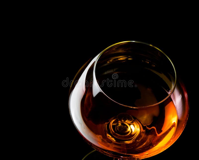 Elegant Brandy in Glass and Bottle at Cellar with Barrels for Wine ...