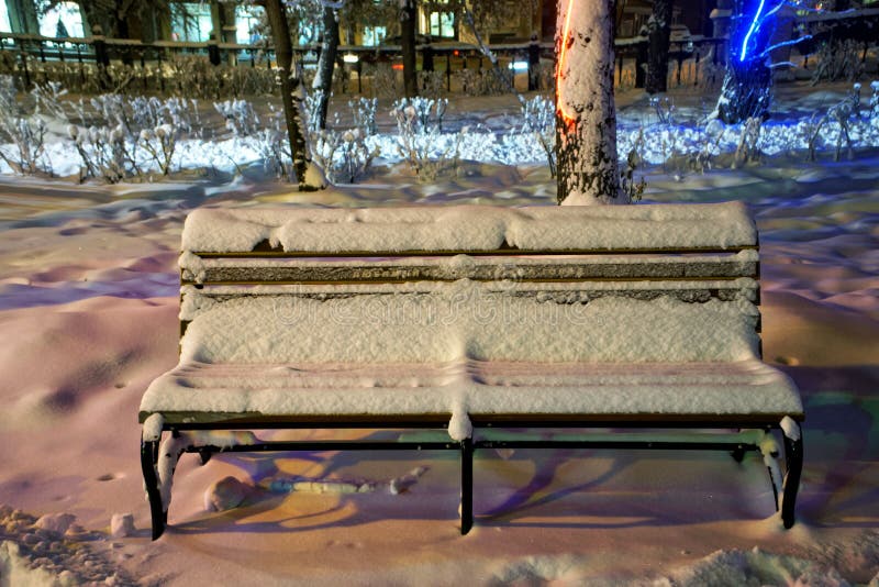 Snow on a Bench in a Winter Night Square. Winter City Stock Photo ...
