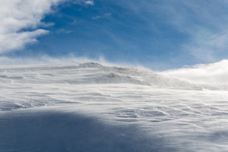 Snow Blowing Over the Edge of a Mountain Stock Photo - Image of summit ...