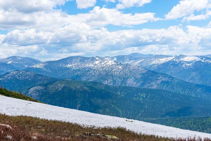 Snow-capped Mid-mountain Peaks and Low-flying Clouds Stock Image ...