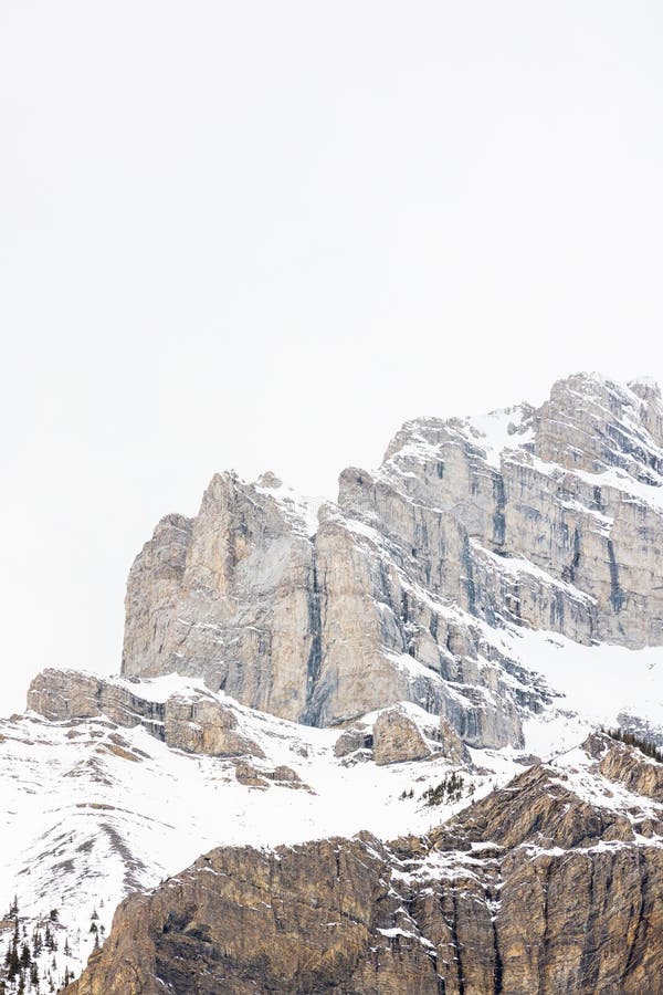 Exposed and Sharp Rock Face Mountain Range Covered in Snow High in the ...