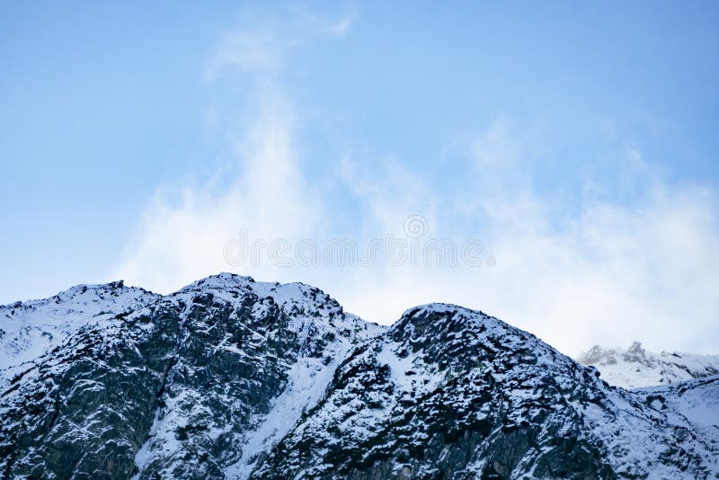 Snow-capped Mountains in the Alps. Clouds Flying Near the Tops of the ...