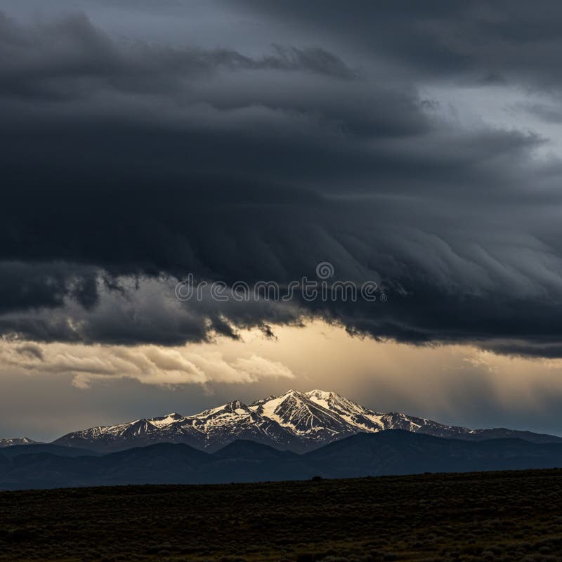 Snow-capped Mountains Under Dramatic Storm Clouds Create a Striking ...