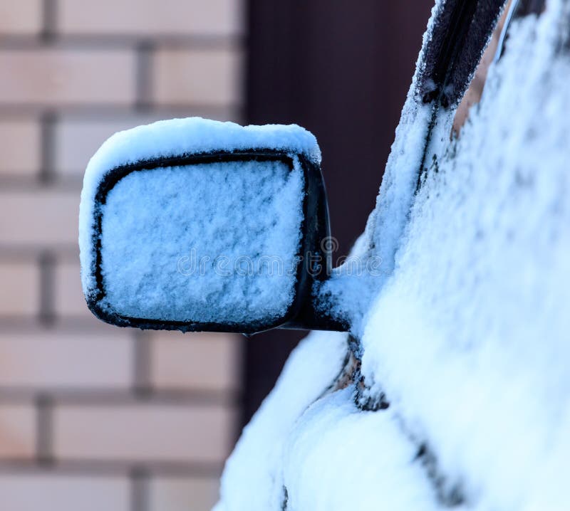Snow on the car mirror stock photo. Image of covered - 200686034