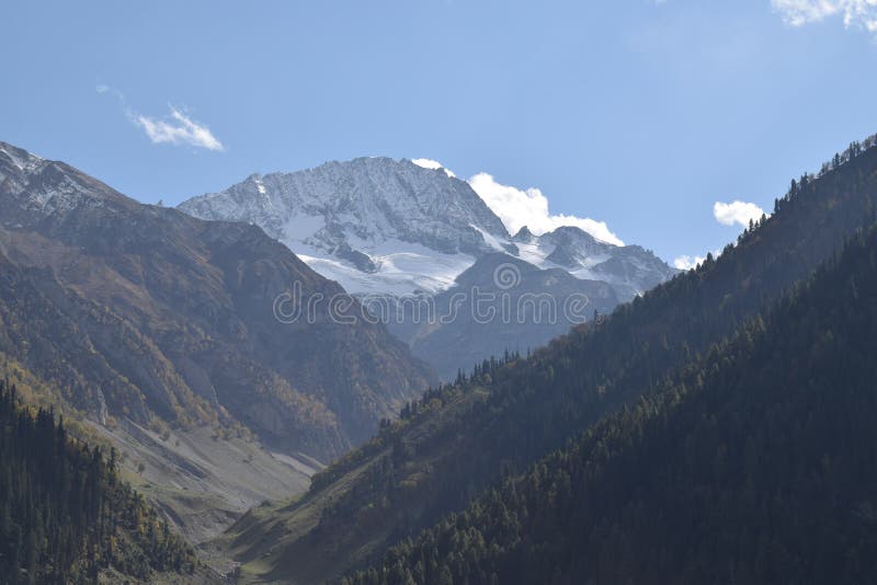 Snow clad mountain peaks stock image. Image of arrangement - 259026527