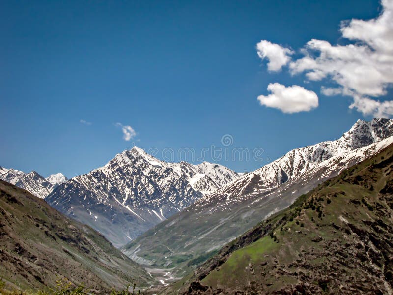 Snow Clad Mountains with White Clouds in Blue Sky Background on Way To ...