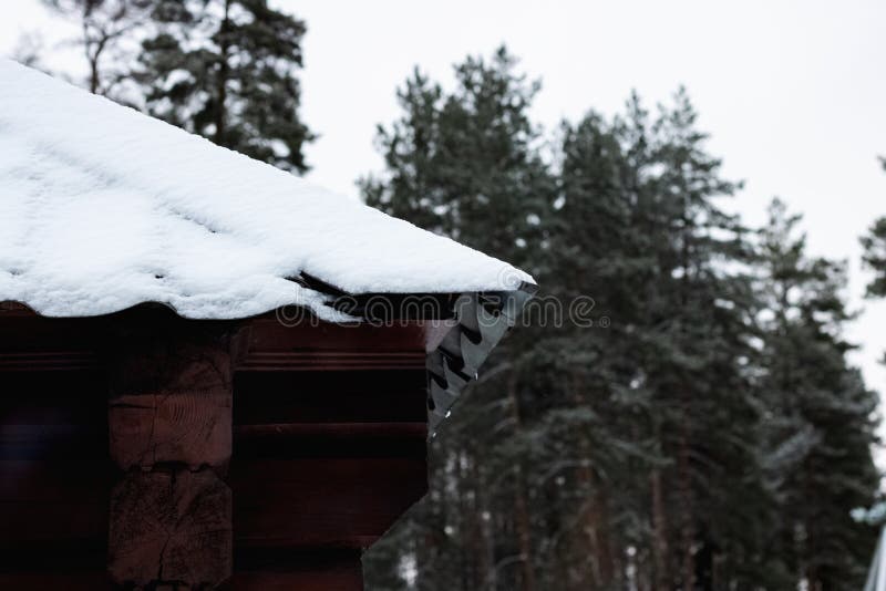 Snow on the Corner of the Roof of a House in the Forest Stock Photo ...