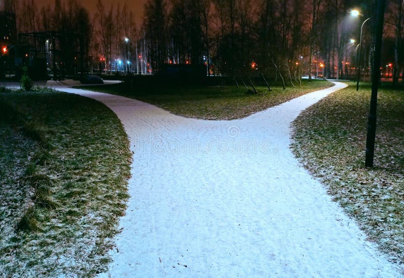 The Snow-covered Alley Divides into Two Directions at Dusk, Leading in ...