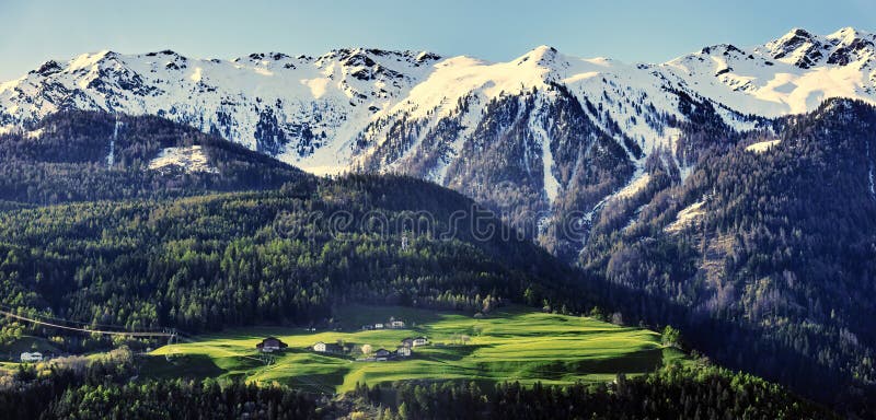 Snow-covered Alpine Peaks in Front of a Green Mountain Pasture in Tyrol ...