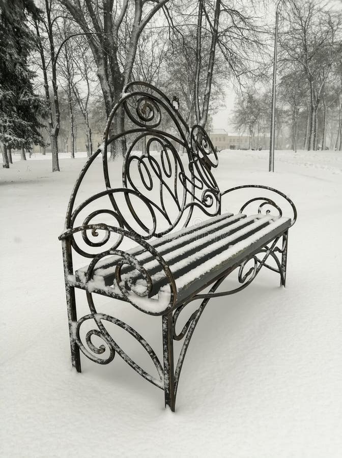 A Snow-covered Bench in the Park. a Beautiful Bench in the Snow. Snowy ...
