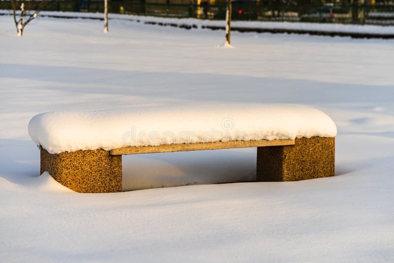 Snow-covered Bench in the Park. Park Bench Covered with Snow from the ...
